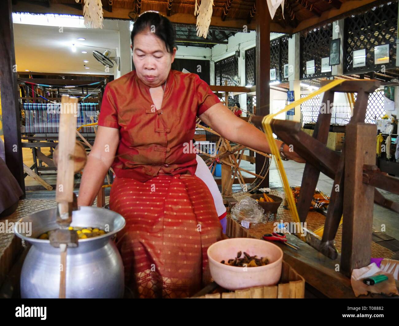CHIANG MAI, THAILAND—MARCH 2018: A woman colors the silk cocoon ...