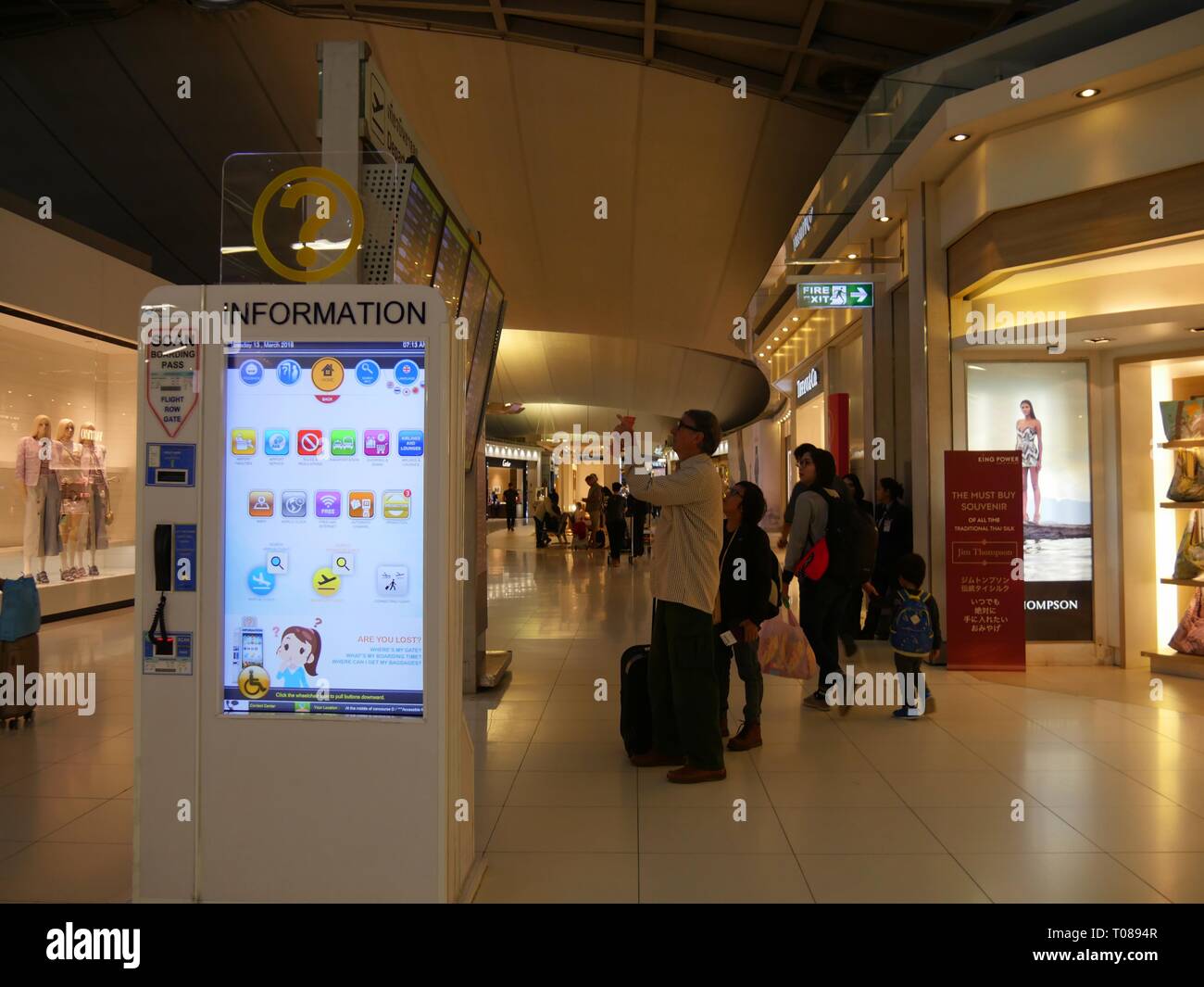 BANGKOK, THAILAND—MARCH 2018: Passengers check out the flight status ...