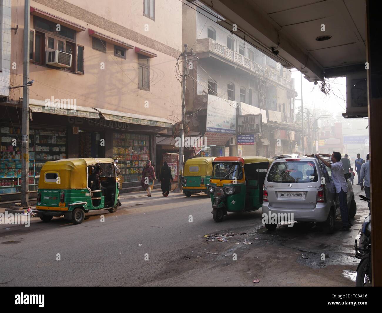 Rickshaws and cars on a street in new delhi hi-res stock photography ...