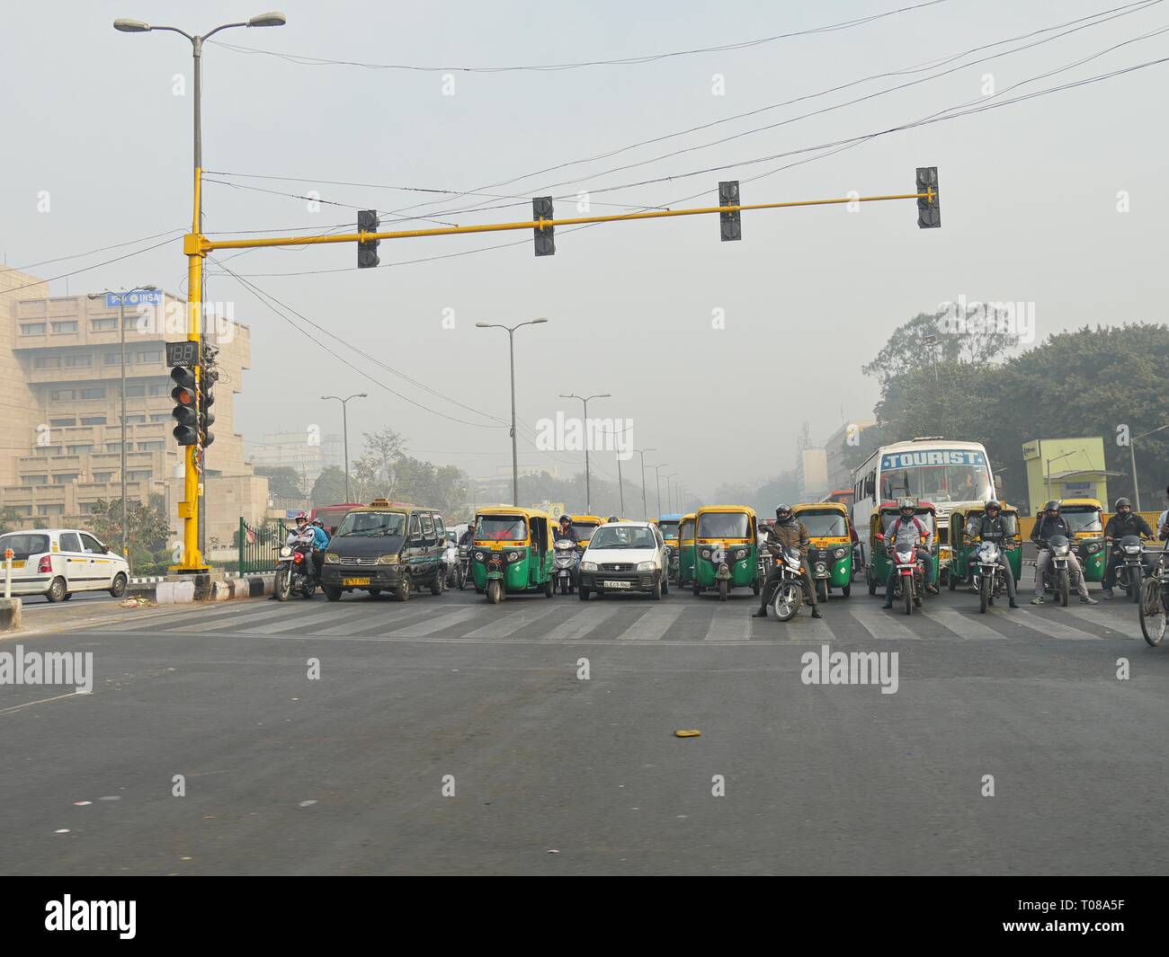 NEW DELHI, INDIA—MARCH 2018: Cars and motorcycles stop on a red light ...