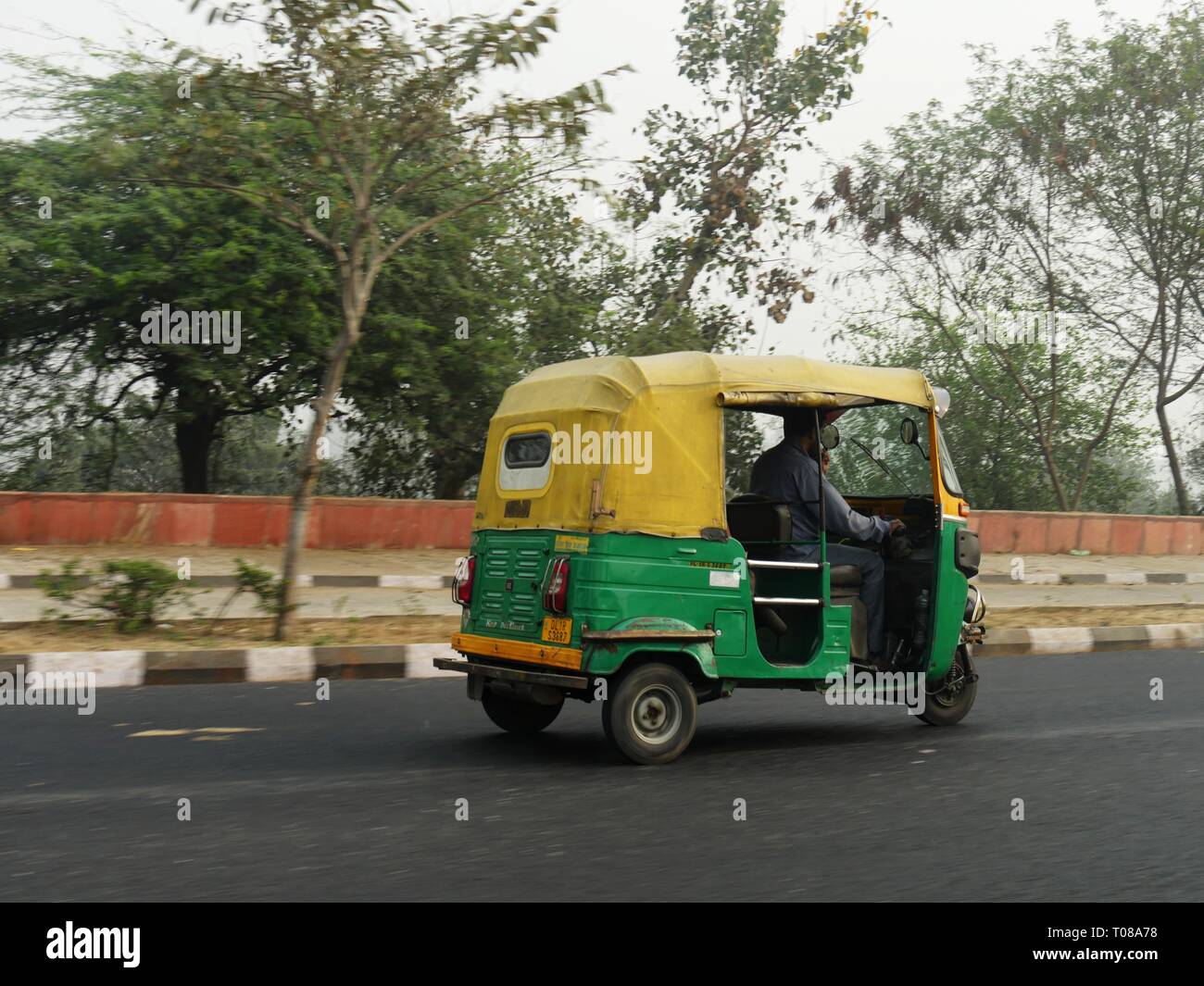 NEW DELHI, INDIA—MARCH 2018: An auto-rickshaw travels on the road in ...