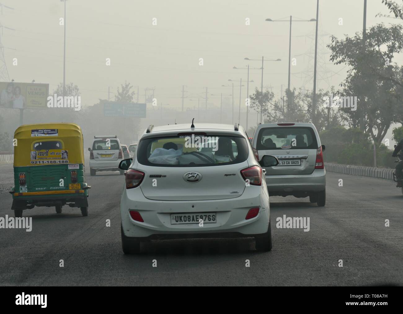 NEW DELHI, INDIA—MARCH 2018: Back view of cars driving by early on a ...