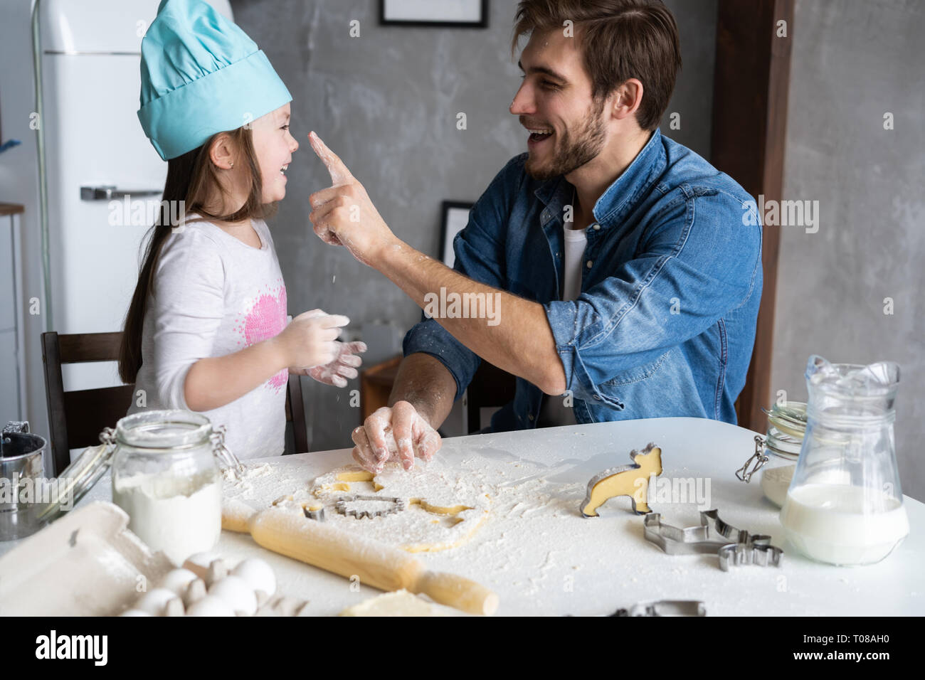 Happy father and daughter having fun while cooking together Stock Photo ...