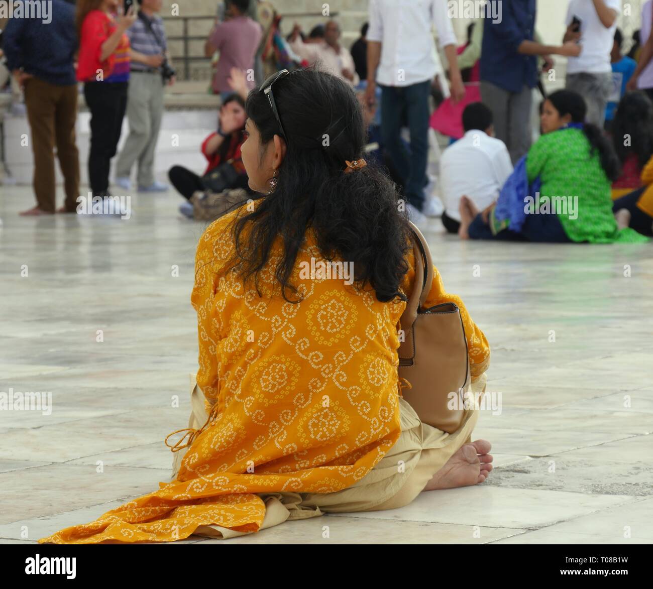AGRA, UTTAR PRADESH, INDIA--MARCH 2018: A woman in bright yellow ...