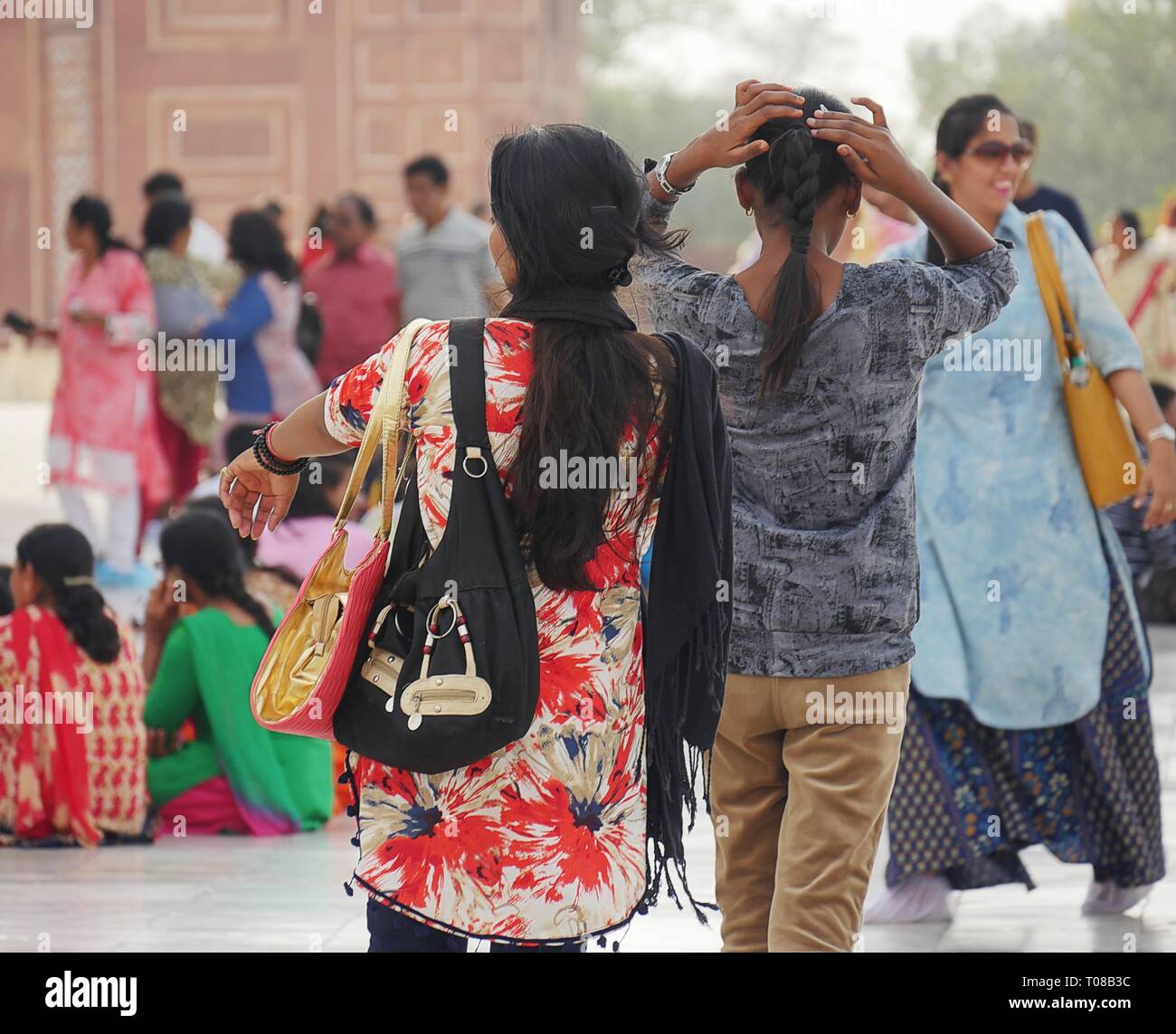 AGRA, UTTAR PRADESH, INDIA--MARCH 2018: Women in traditional sari walk ...