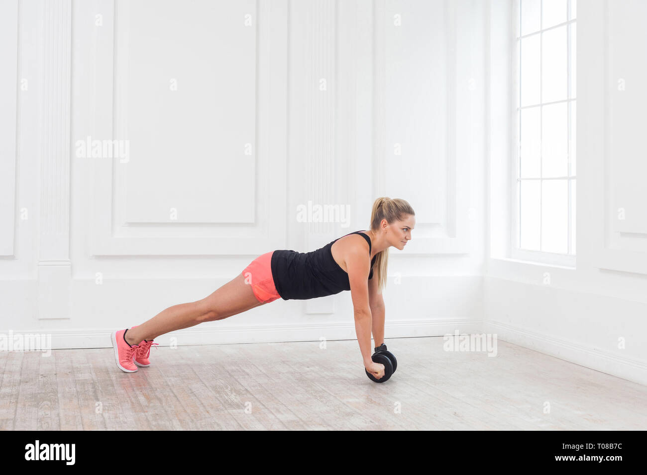 Full length side view portrait of athletic young woman in fit wear ...