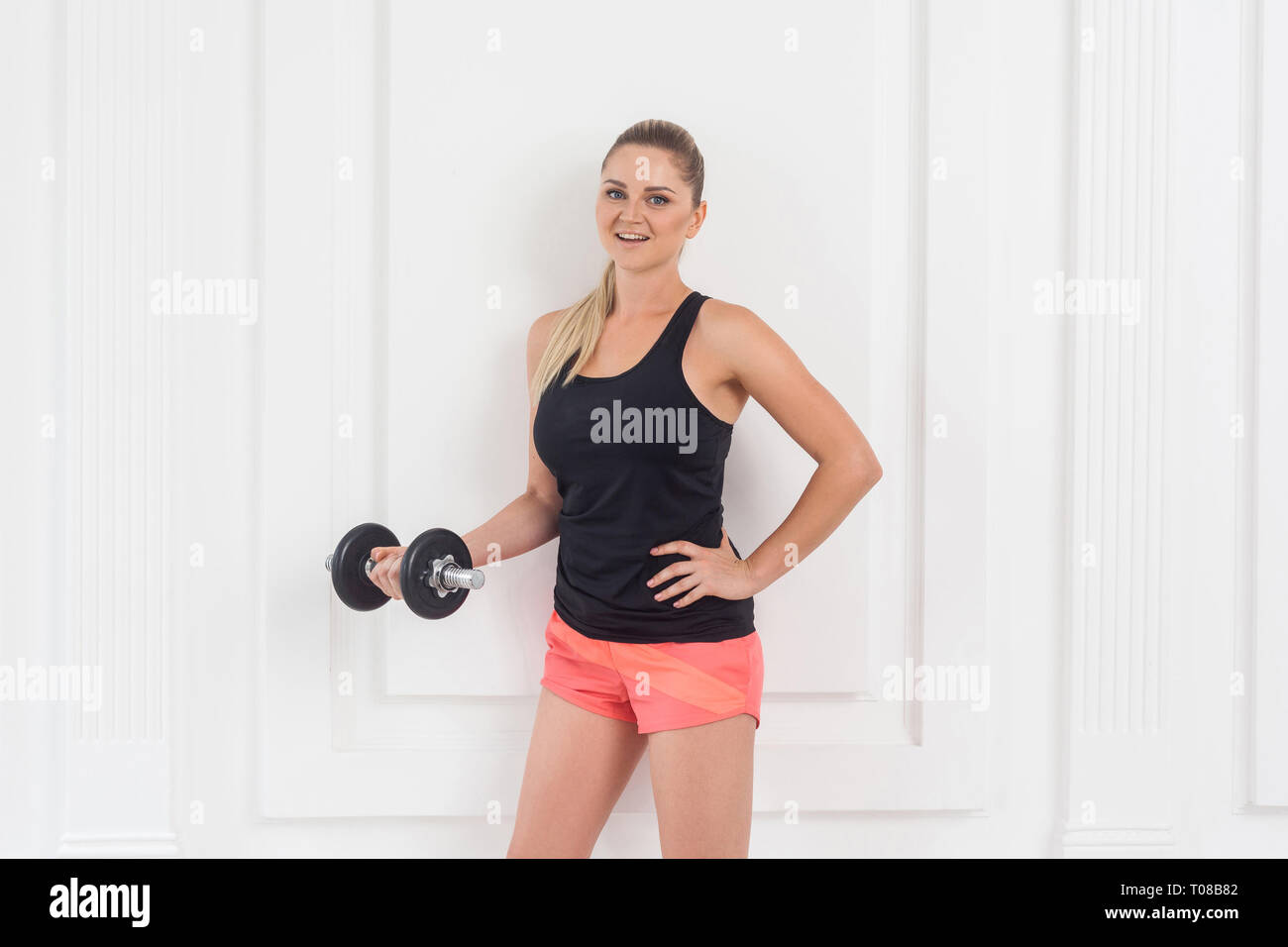 Young adult satisfied athletic beautiful bodybuilder woman in pink ...