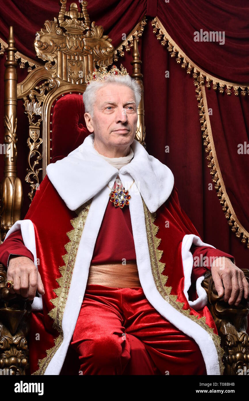 Portrait of confident senior man in red cloak Stock Photo - Alamy