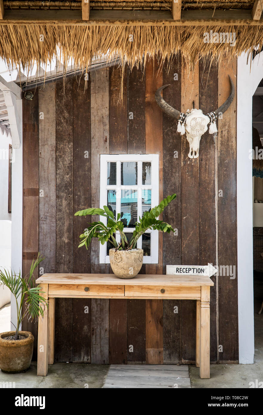 Close up of exotic wooden reception desk sign in a tropical motel ...