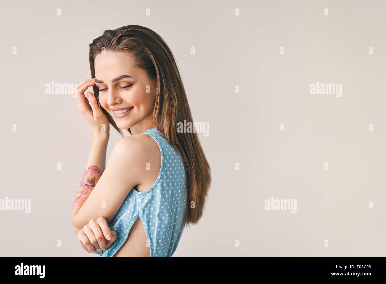 Portrait of shy smiling beautiful woman looking down copy space. Beauty ...