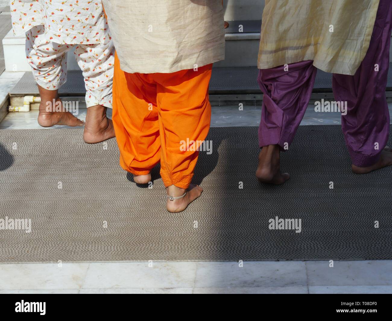 Devotees wash their feet before entering the Gurdwara Bangla Sahib at ...