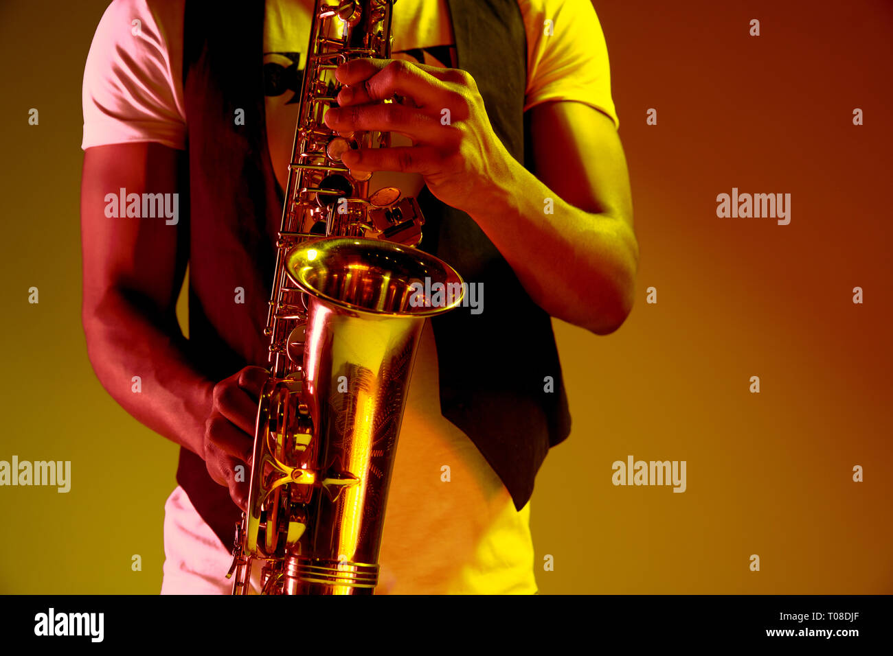 African American handsome jazz musician playing the saxophone in the ...