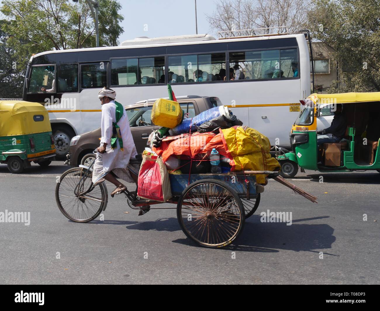NEW DELHI, INDIA—MARCH 2018: A man pedals an overloaded cycle rickshaw ...