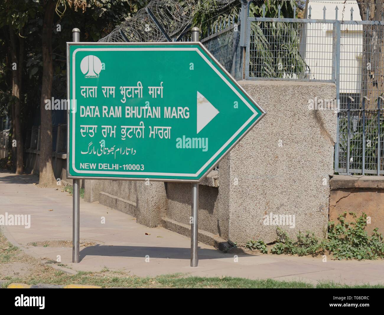 NEW DELHI, INDIA--MARCH 2018: Directional sign by the side of a street ...