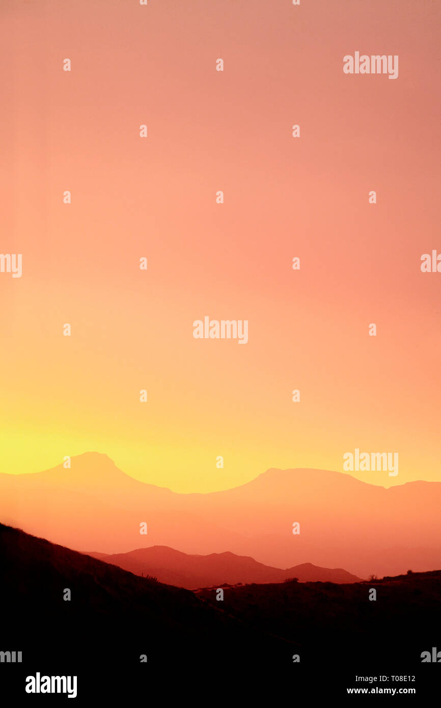 Africa, Namibia, Damaraland. Dramatic sunset caused by atmospheric dust ...