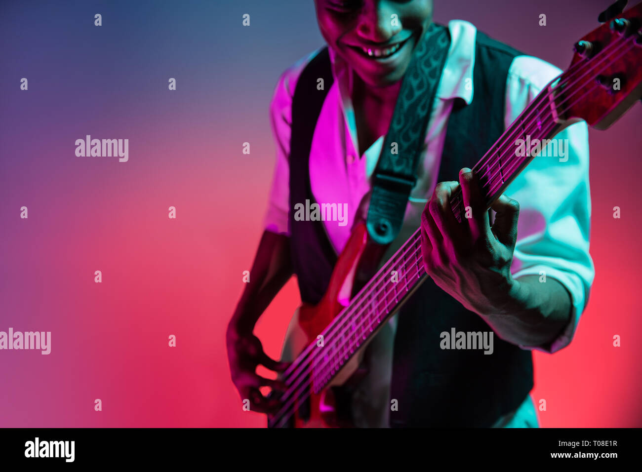 African American handsome jazz musician playing bass guitar in the ...