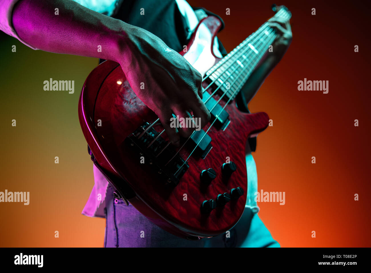 African American handsome jazz musician playing bass guitar in the ...