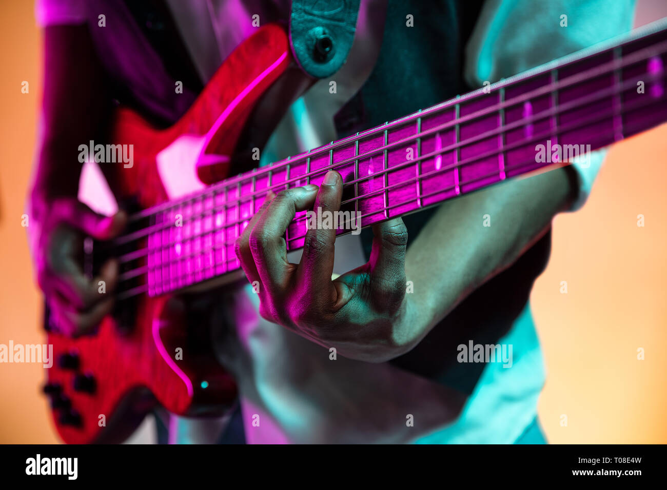 African American handsome jazz musician playing bass guitar in the ...