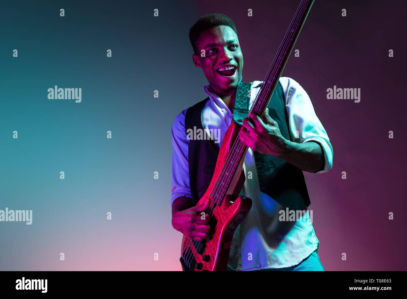 African American handsome jazz musician playing bass guitar in the ...