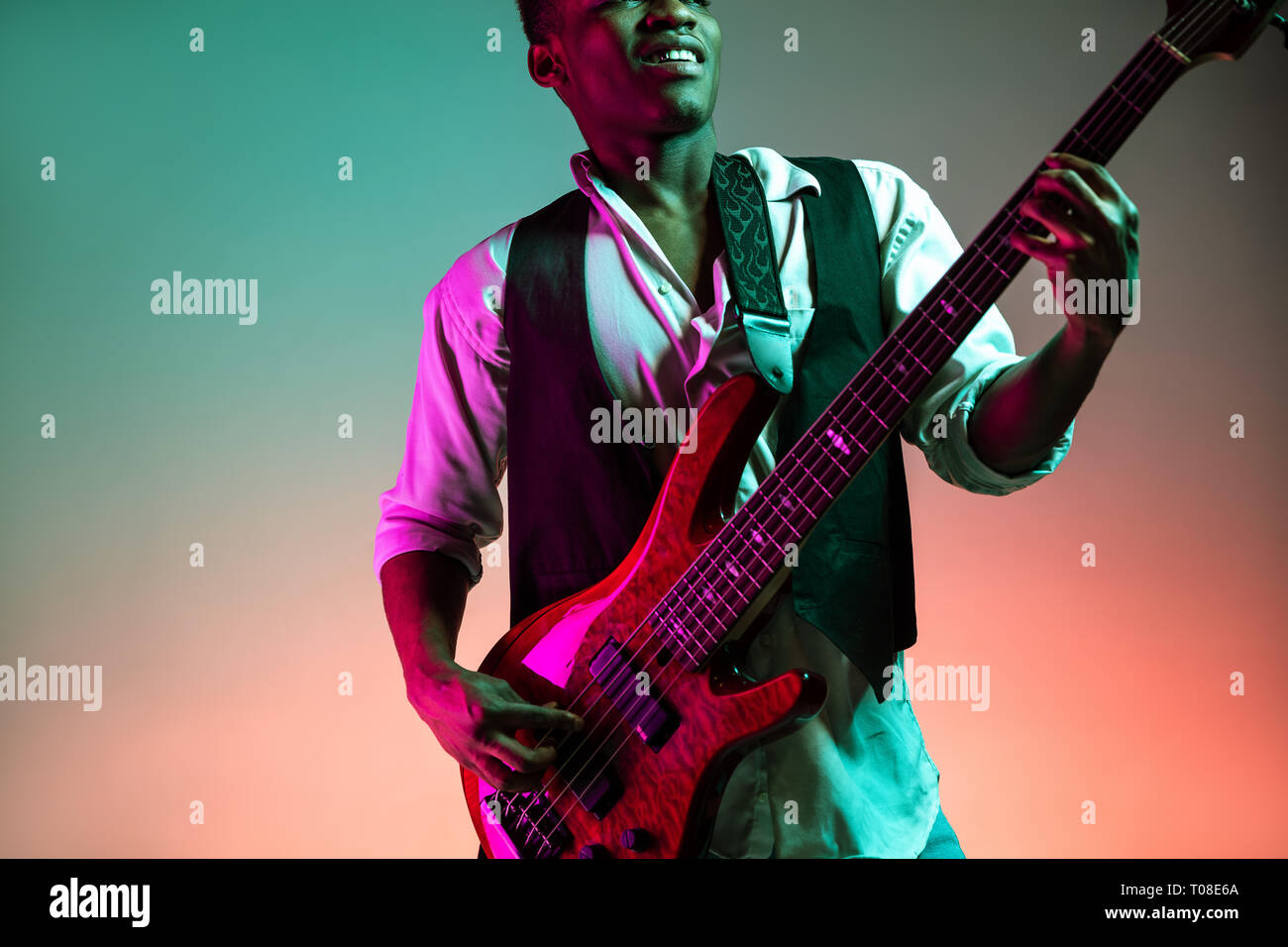 African American handsome jazz musician playing bass guitar in the ...