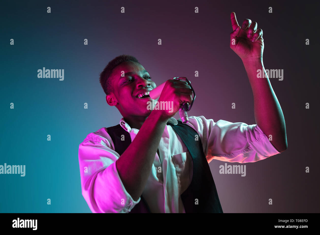 African American handsome jazz musician singing into the microphone in ...
