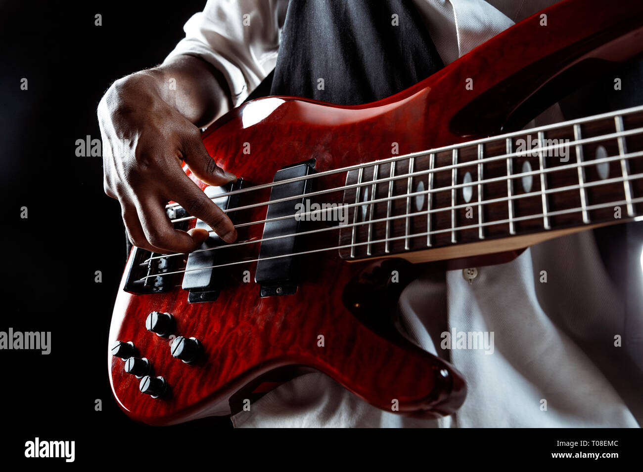 African American handsome jazz musician playing bass guitar in the ...