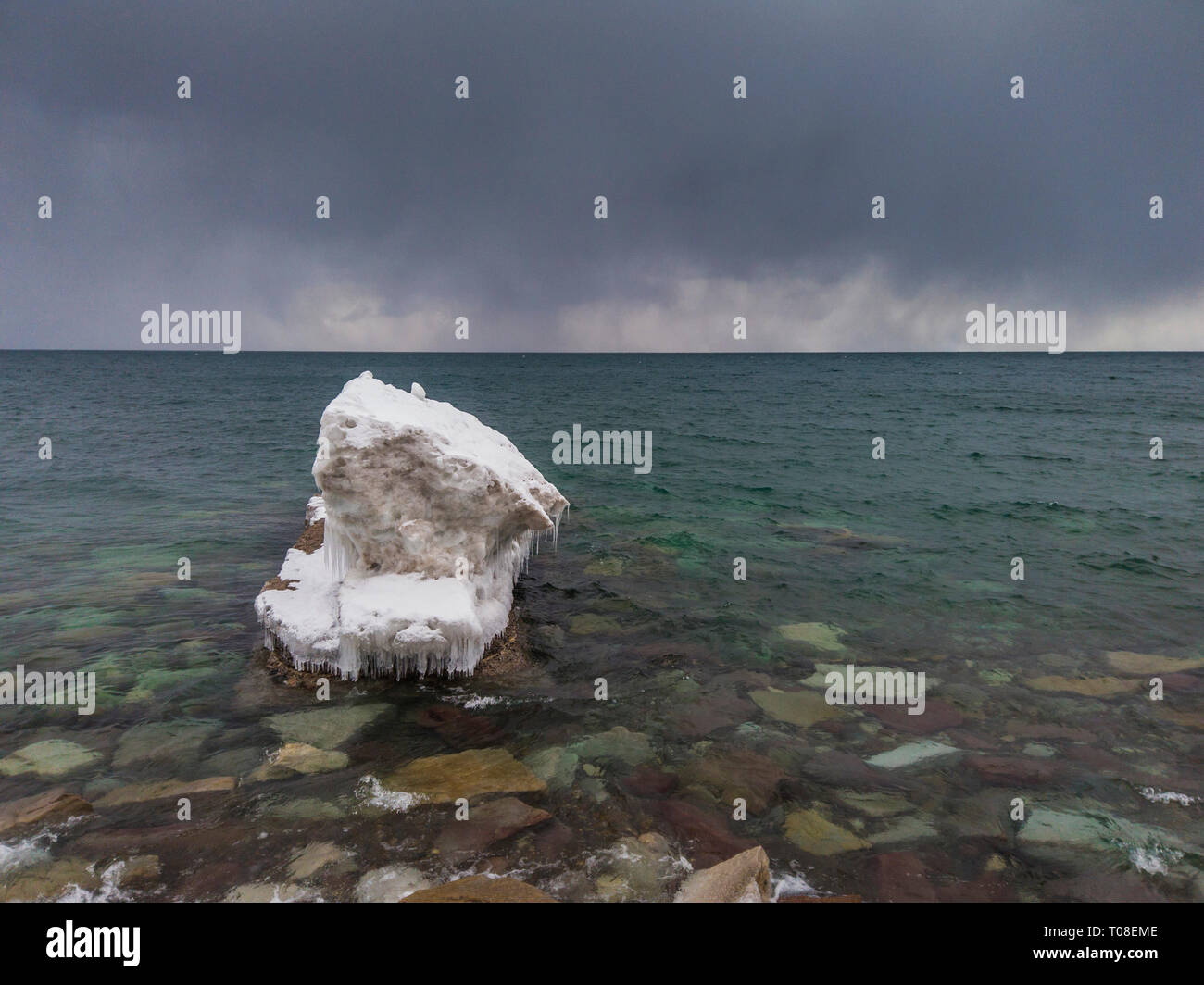 An frozen iceberg floating on the surface of the ocean Stock Photo - Alamy