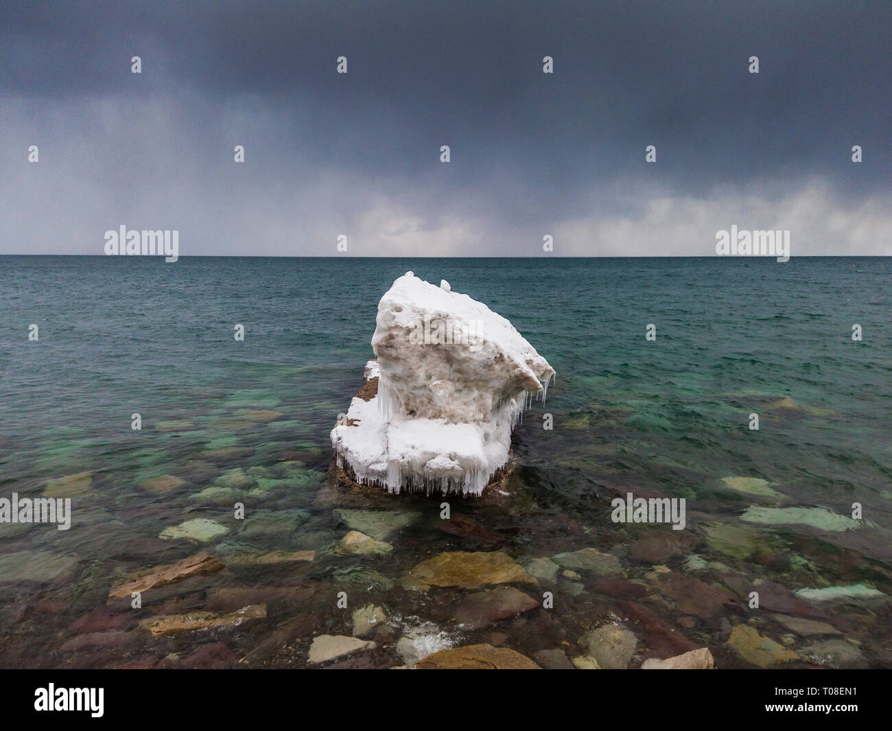 An frozen iceberg floating on the surface of the ocean Stock Photo - Alamy