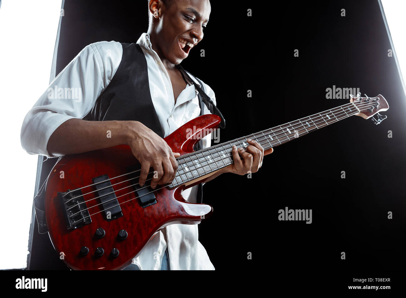 African American handsome jazz musician playing bass guitar in the ...