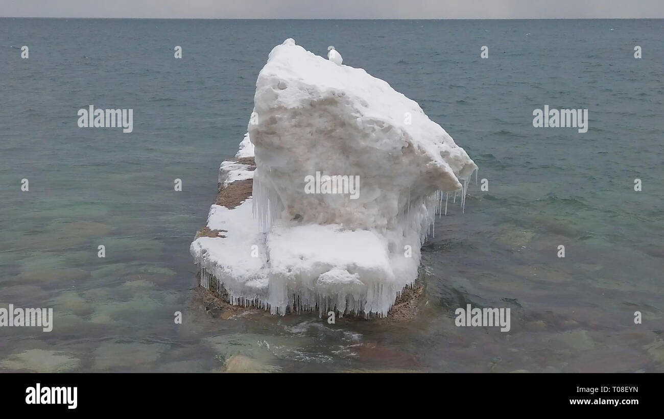 An frozen iceberg floating on the surface of the ocean Stock Photo - Alamy