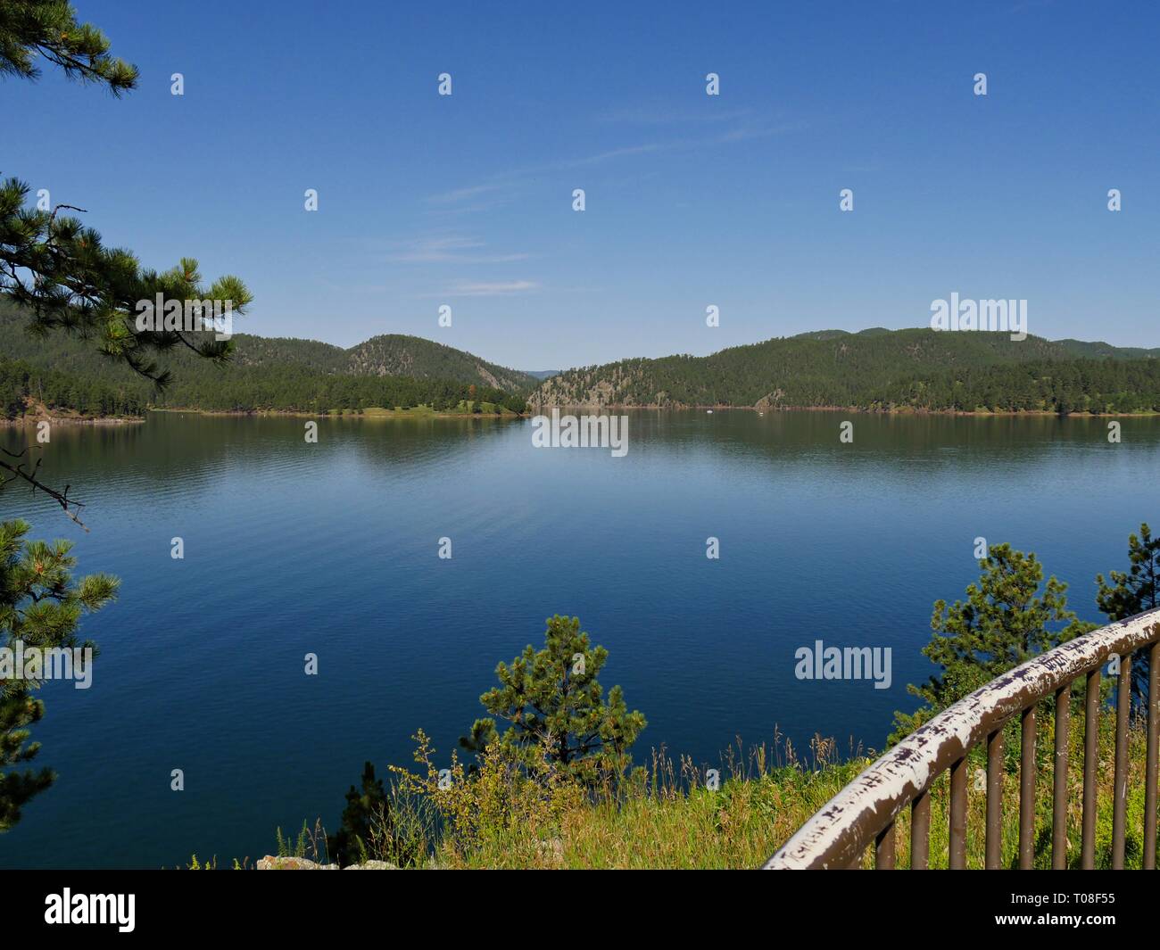 Scenic view of Lake Pactola with the railings of the fence in picture ...