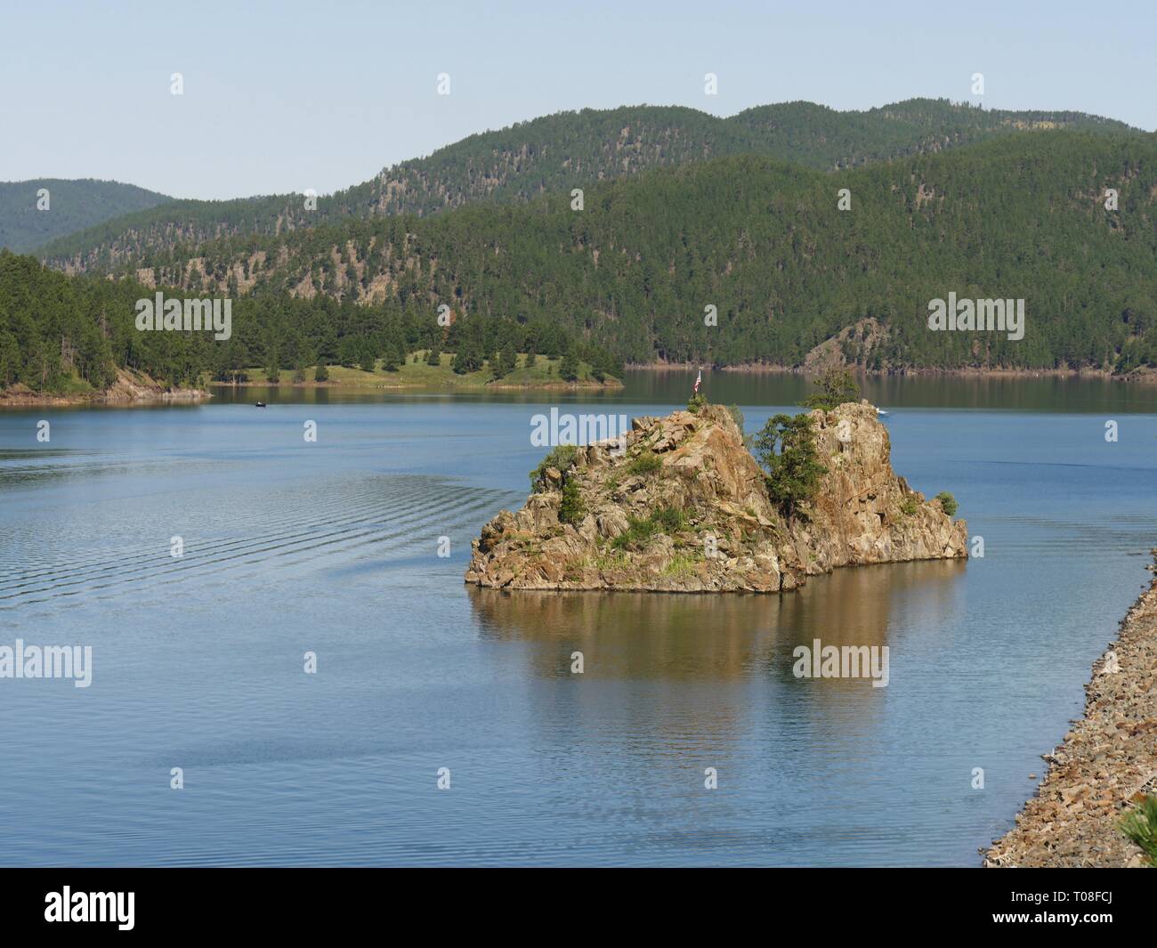 View of Lake Pactola with a rocky islet. It is the largest reservoir in ...