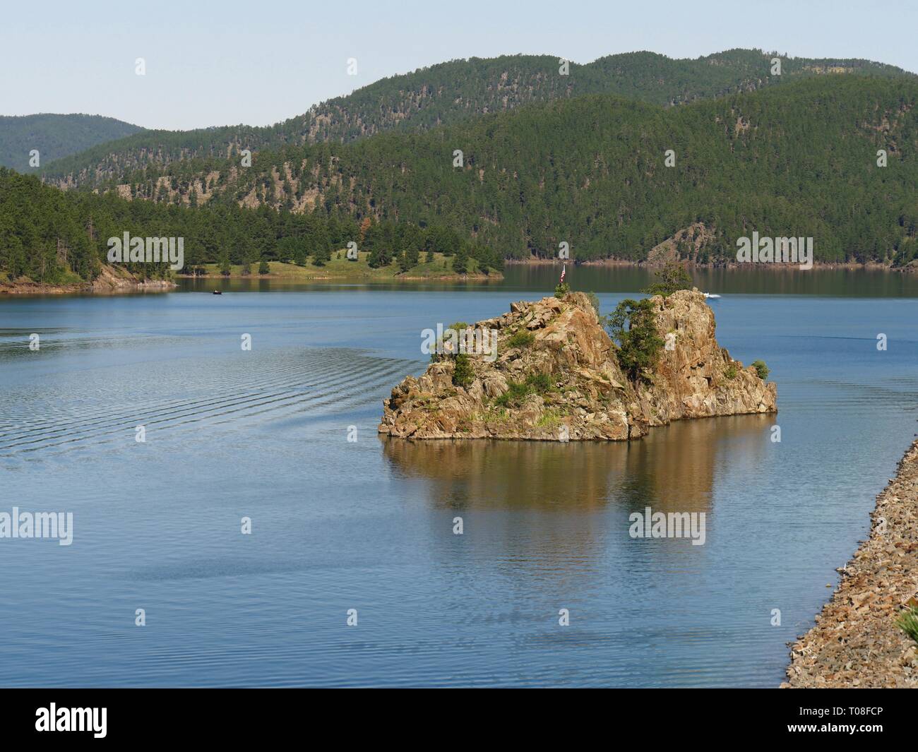 Lake Pactola with a rocky islet. Lake Pactola is the largest reservoir ...