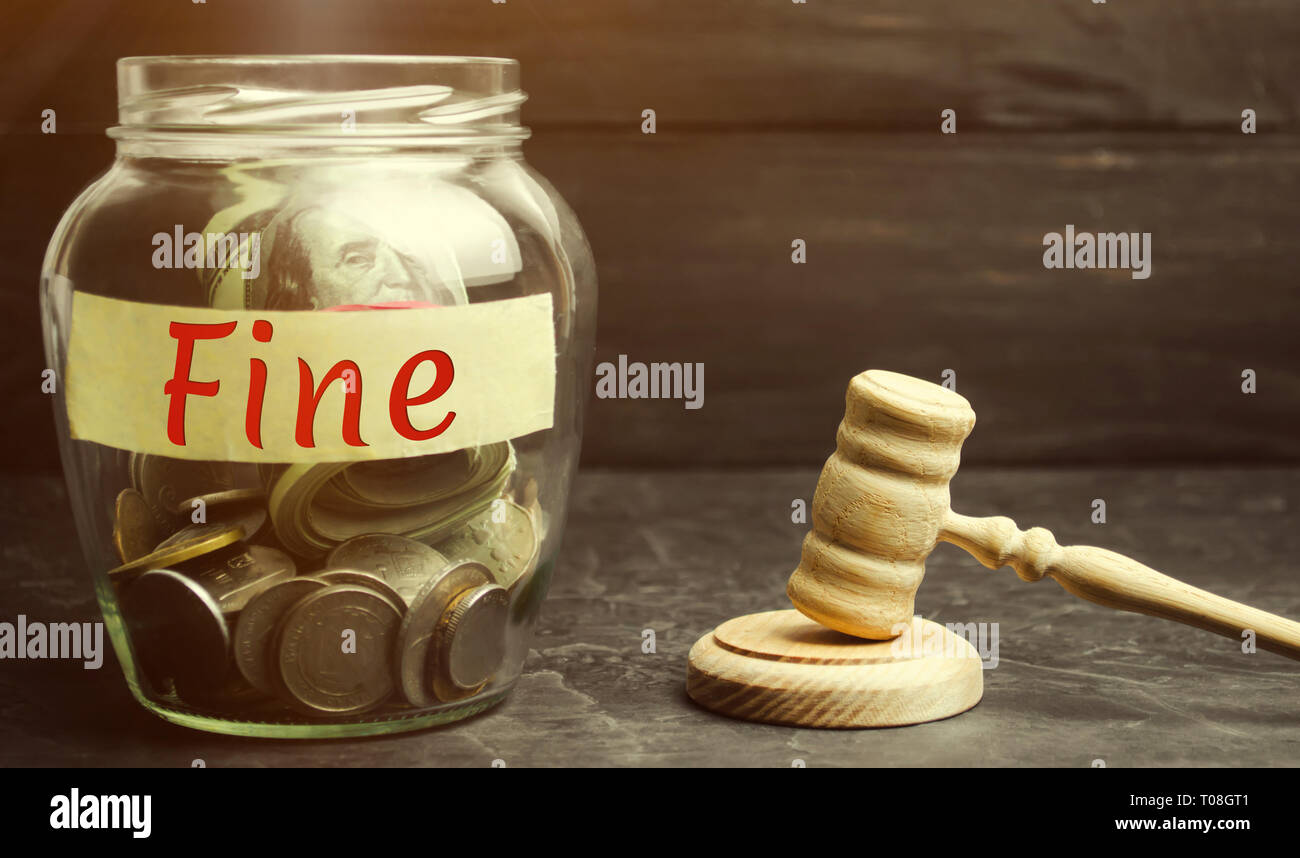 Glass jar with the word Fine and the judge's hammer. Penalty as a ...