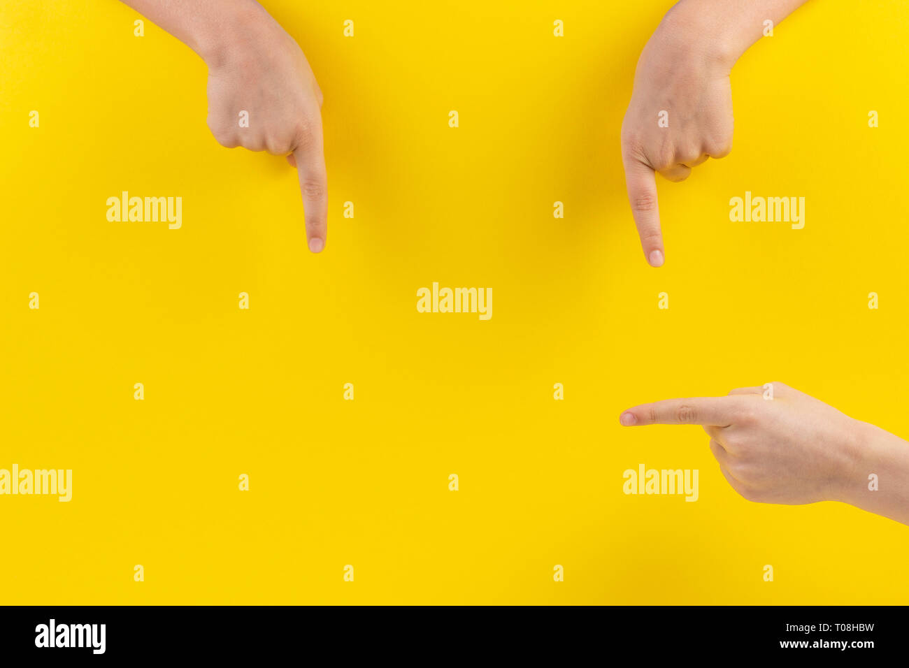 Child hands fingers pointing on yellow background Stock Photo - Alamy
