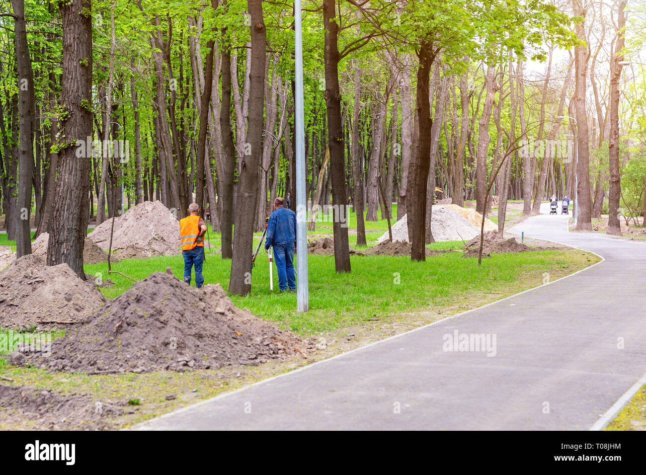 Workers and engineer measuring distance with special gauge tool ...
