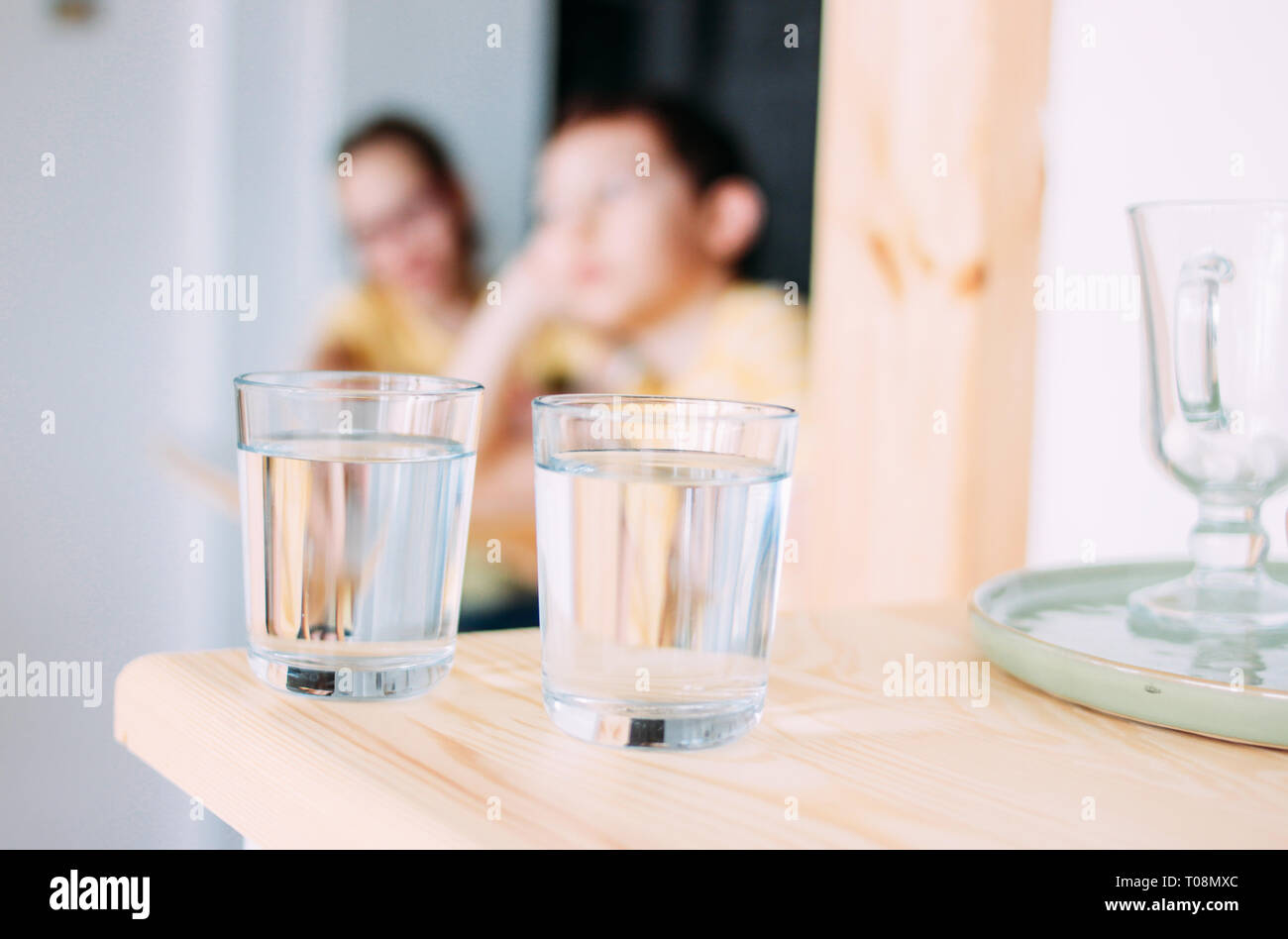 Two glasses of clean water, children in the background Stock Photo - Alamy