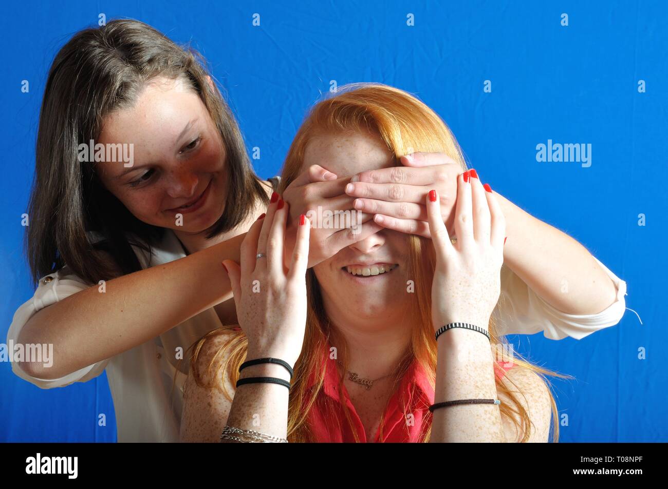 Complicity between two teens: hello, guess who I am Stock Photo - Alamy