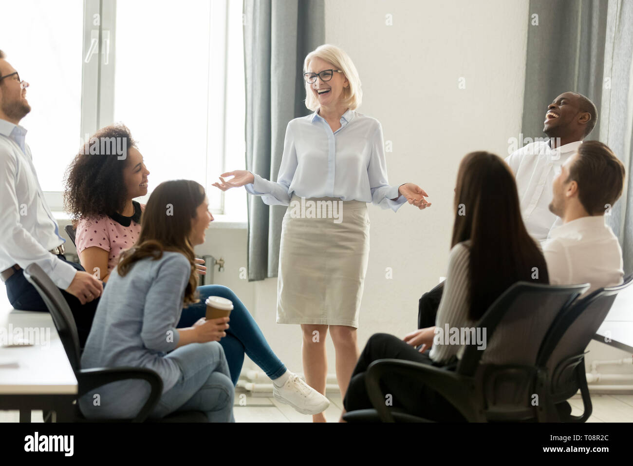 Female business coach leader and team people laughing at training Stock ...