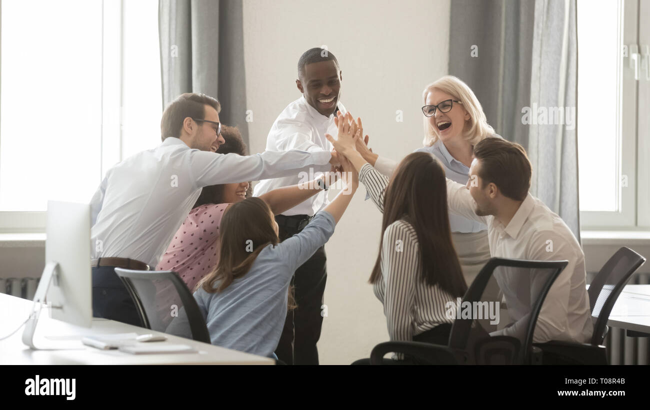 Happy diverse employees business team engaged in teambuilding giving ...