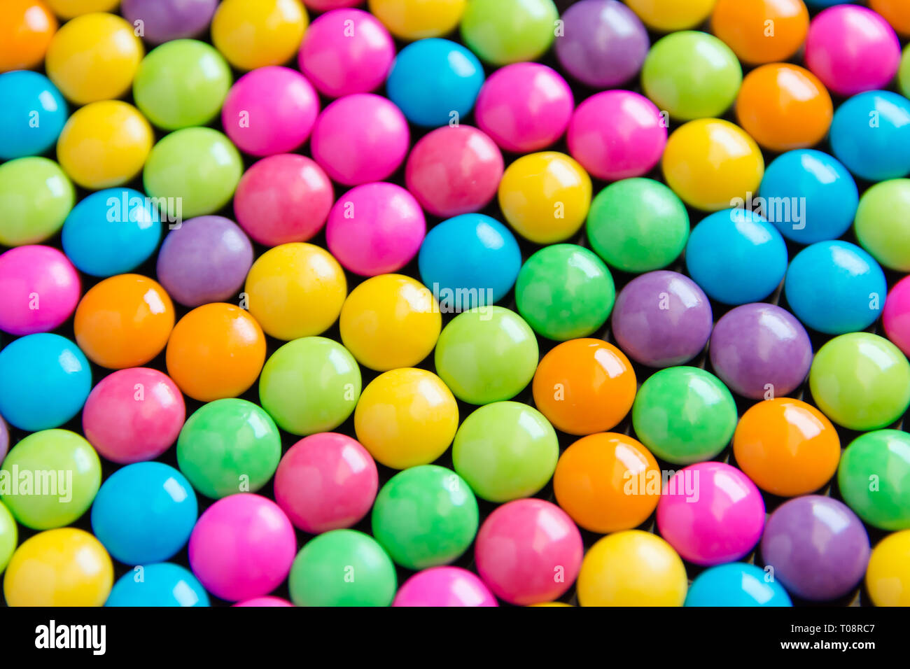 Pile of colorful sweet candy chocolates coated background. colourful ...