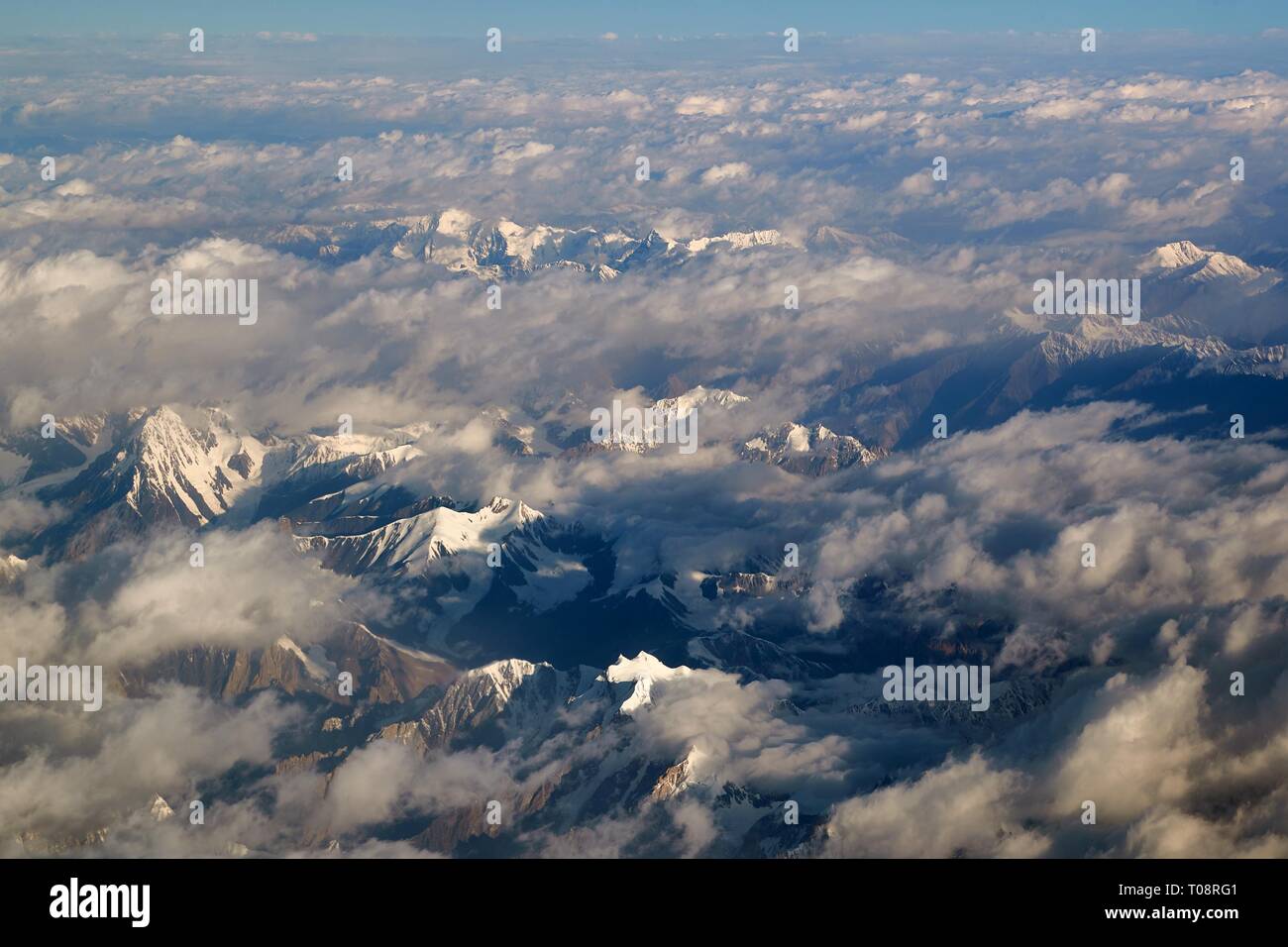 Plane flying over rocky mountains hi-res stock photography and images ...