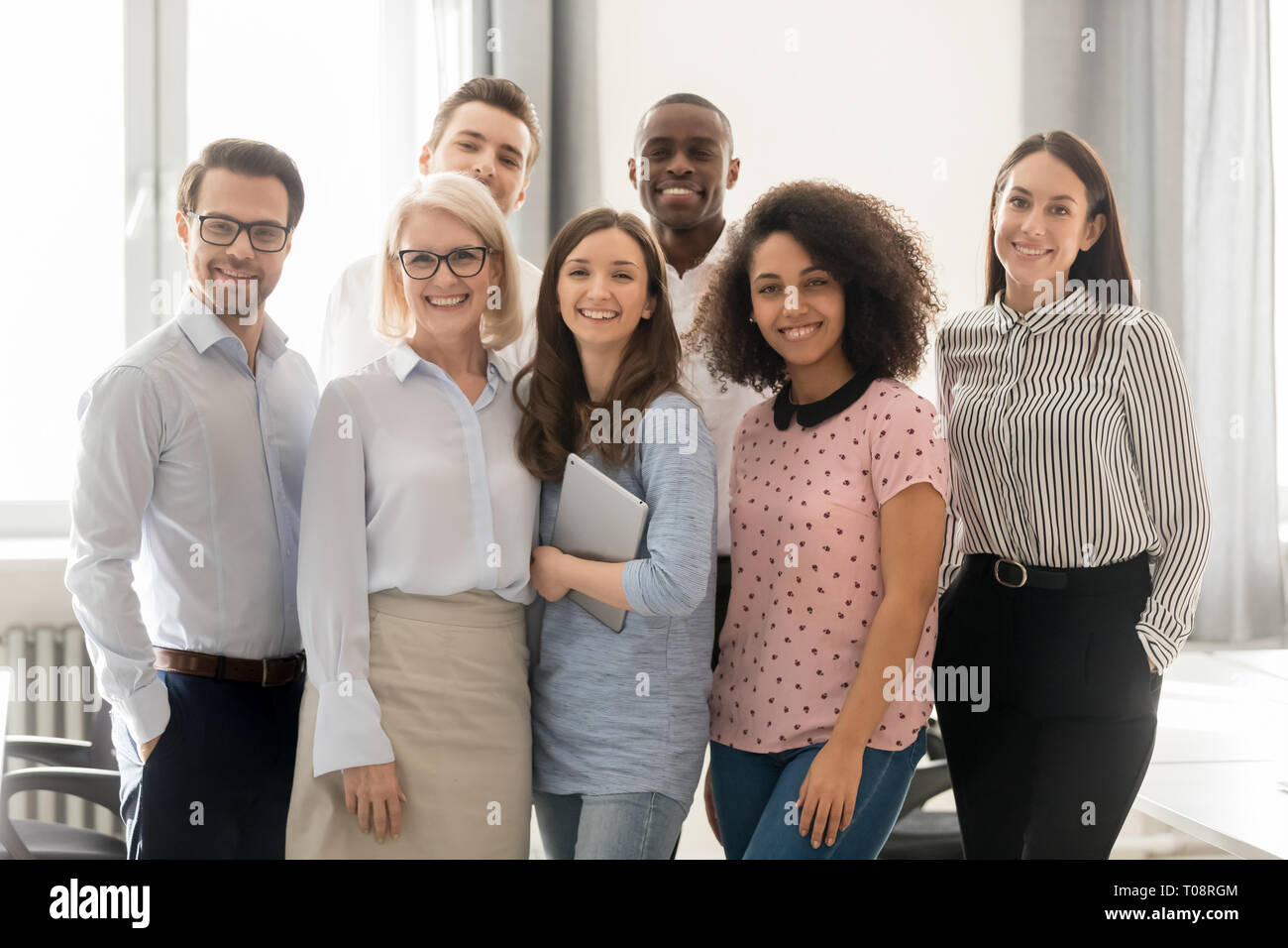 Happy multicultural work team looking at camera posing in office Stock ...