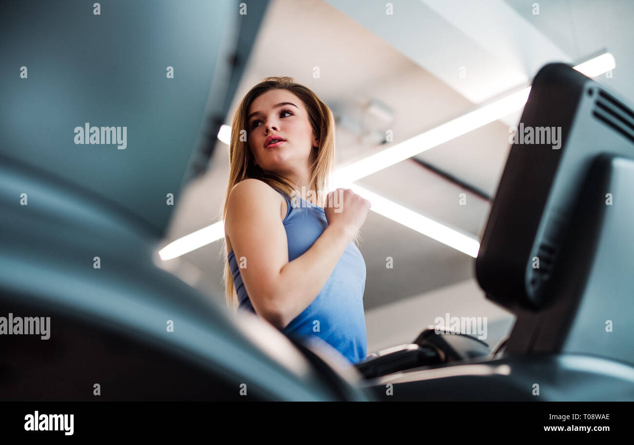 A portrait of young girl or woman doing cardio workout in a gym Stock ...
