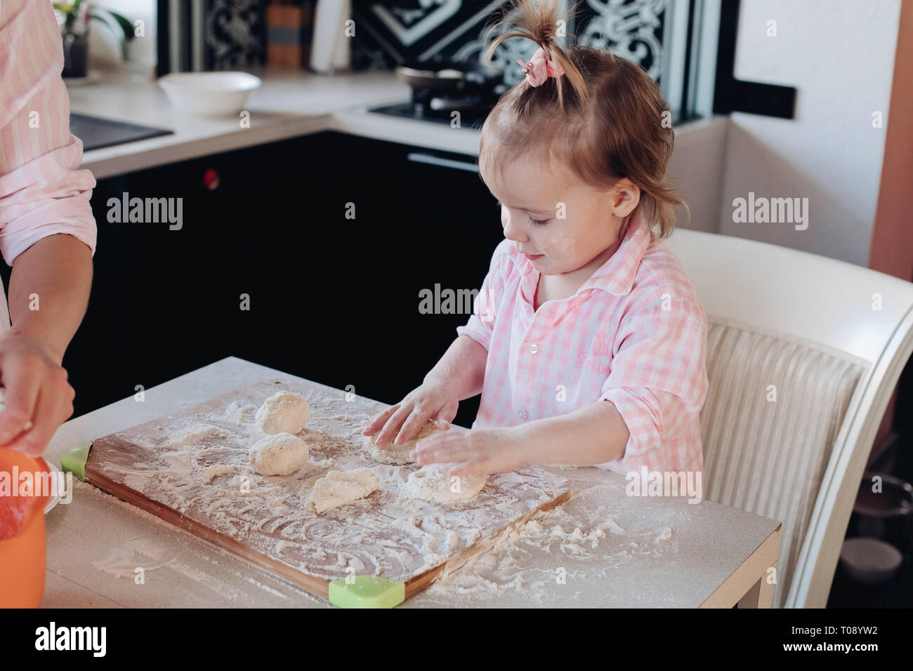 Adorable kid cooking with mum in the kitchen Stock Photo - Alamy