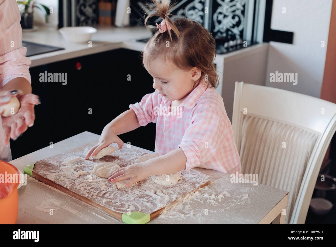 Adorable kid cooking with mum in the kitchen Stock Photo - Alamy