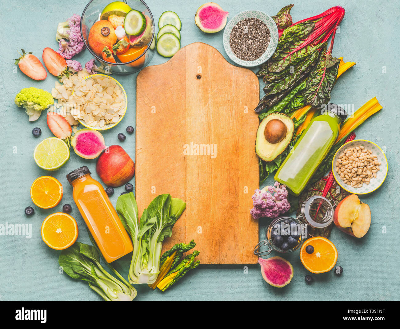Healthy smoothie ingredients around wooden cutting board, top view ...