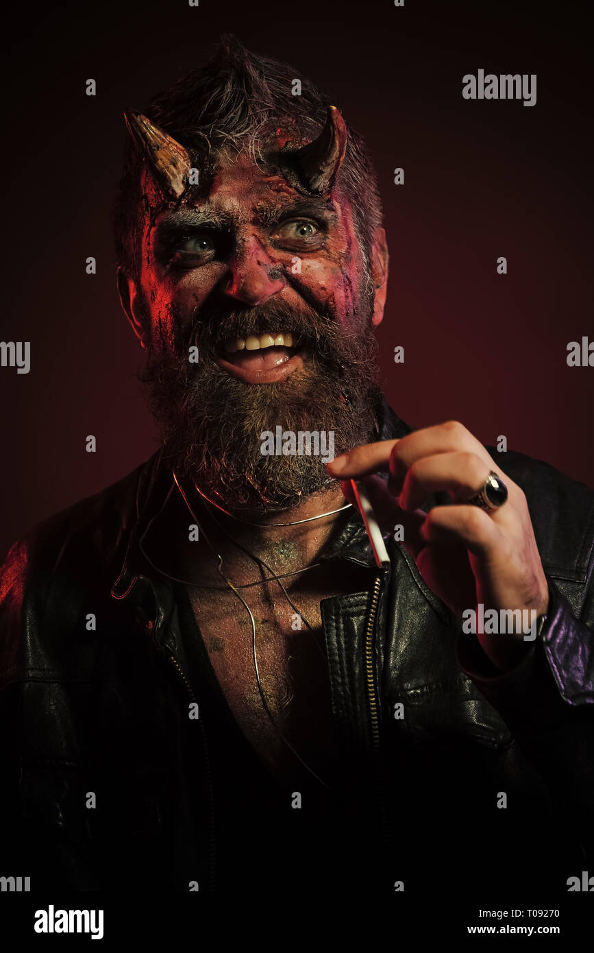 Halloween devil smoking cigarette Stock Photo - Alamy