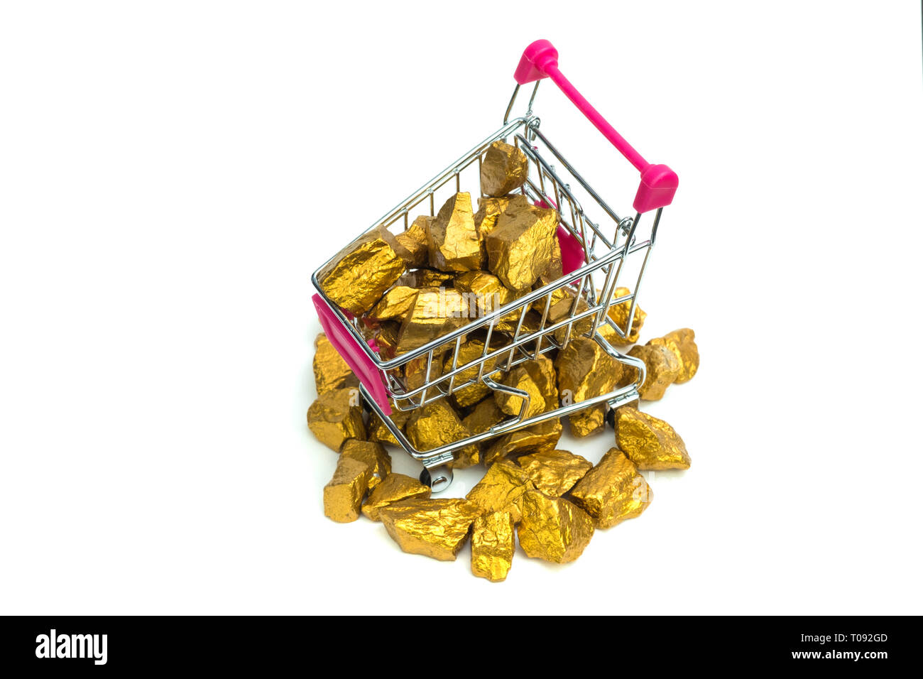 Pile of gold nuggets or gold ore in shopping cart or supermarket ...