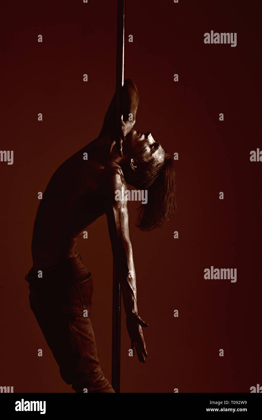 sportsman on pylon, sportsman dancing on pole with silver body Stock ...